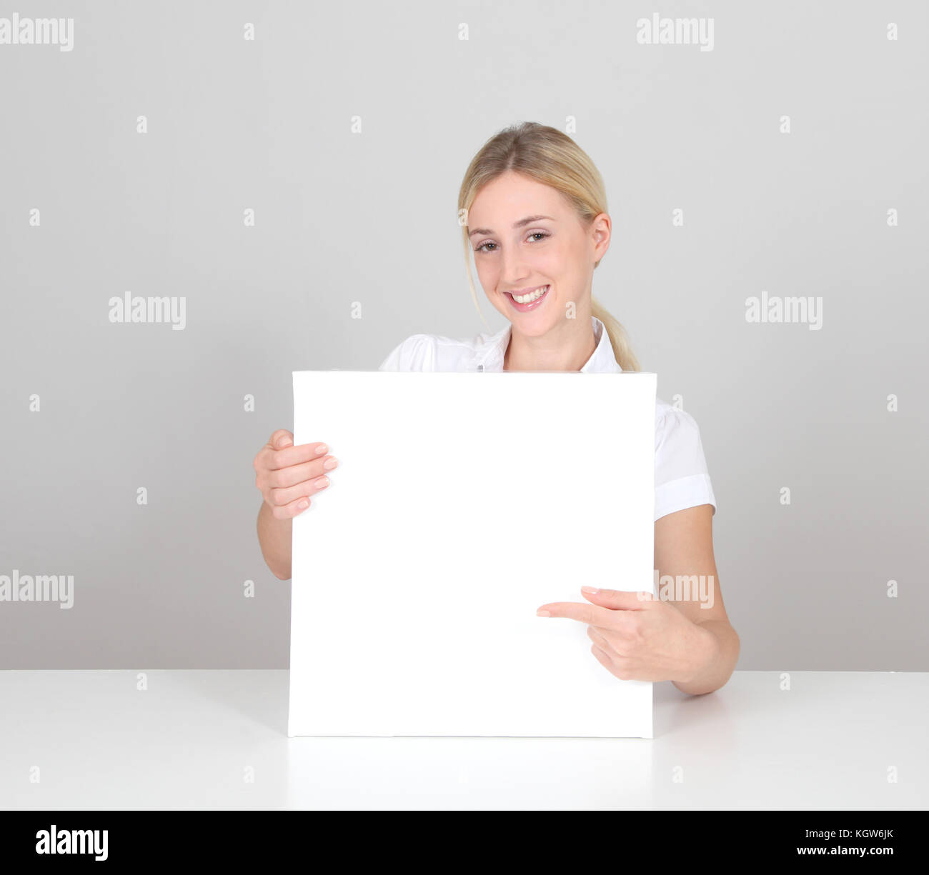 Smiling woman showing message board Stock Photo - Alamy