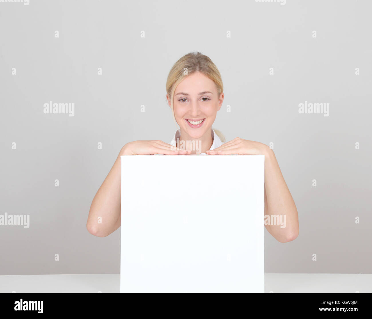 Smiling woman showing message board Stock Photo - Alamy