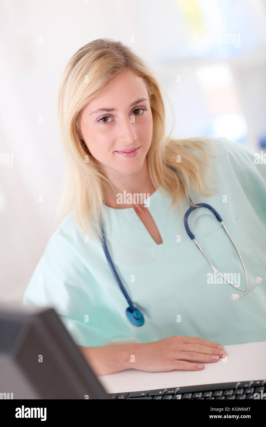 Portrait of nurse working on desktop computer Stock Photo - Alamy