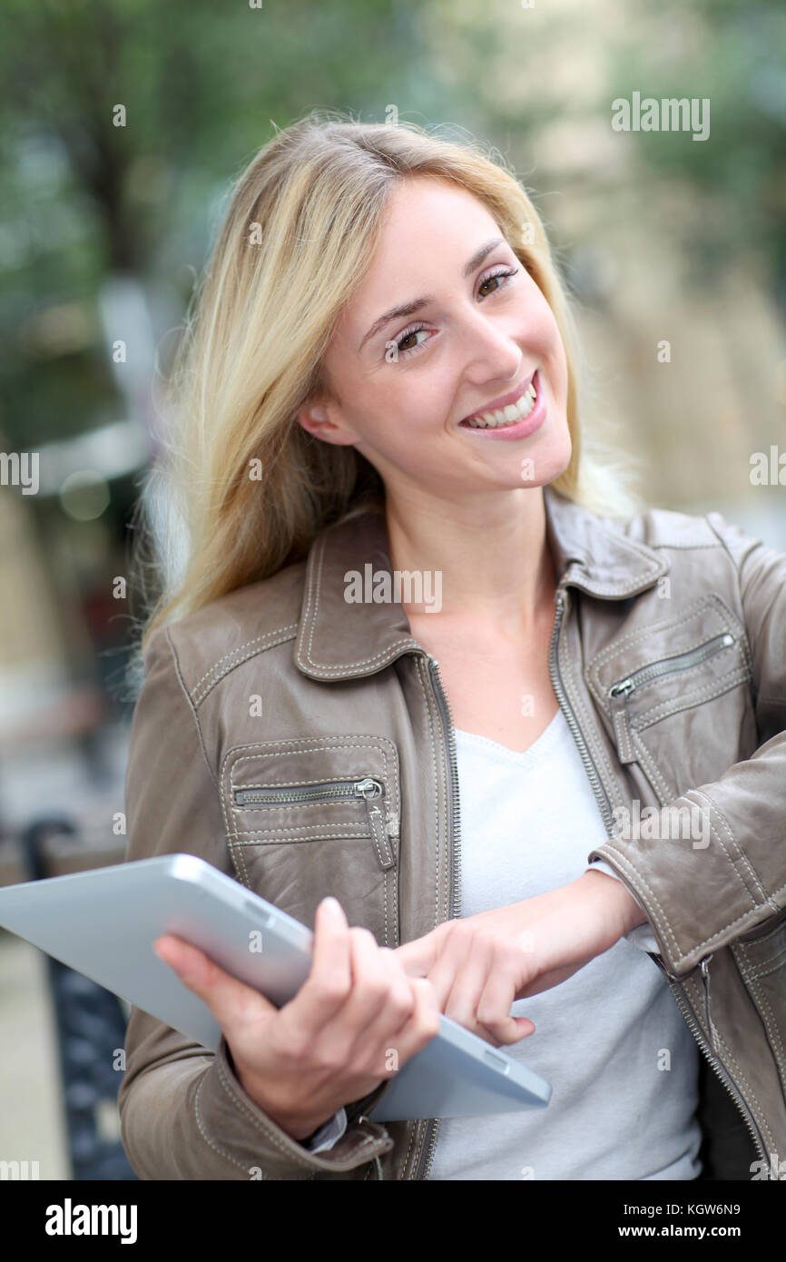 Beautiful woman using electronic tablet in public park Stock Photo - Alamy