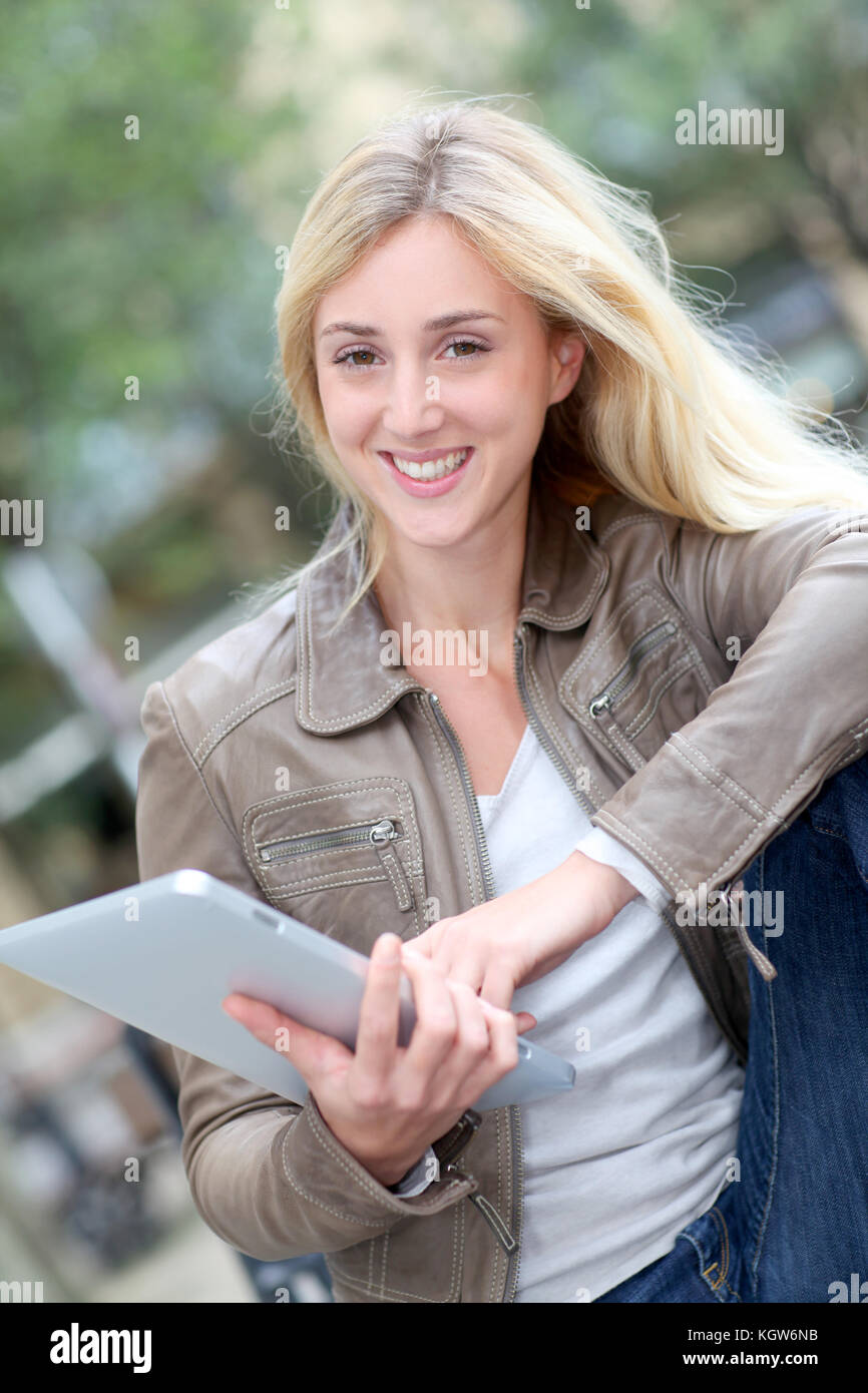 Beautiful woman using electronic tablet in public park Stock Photo - Alamy