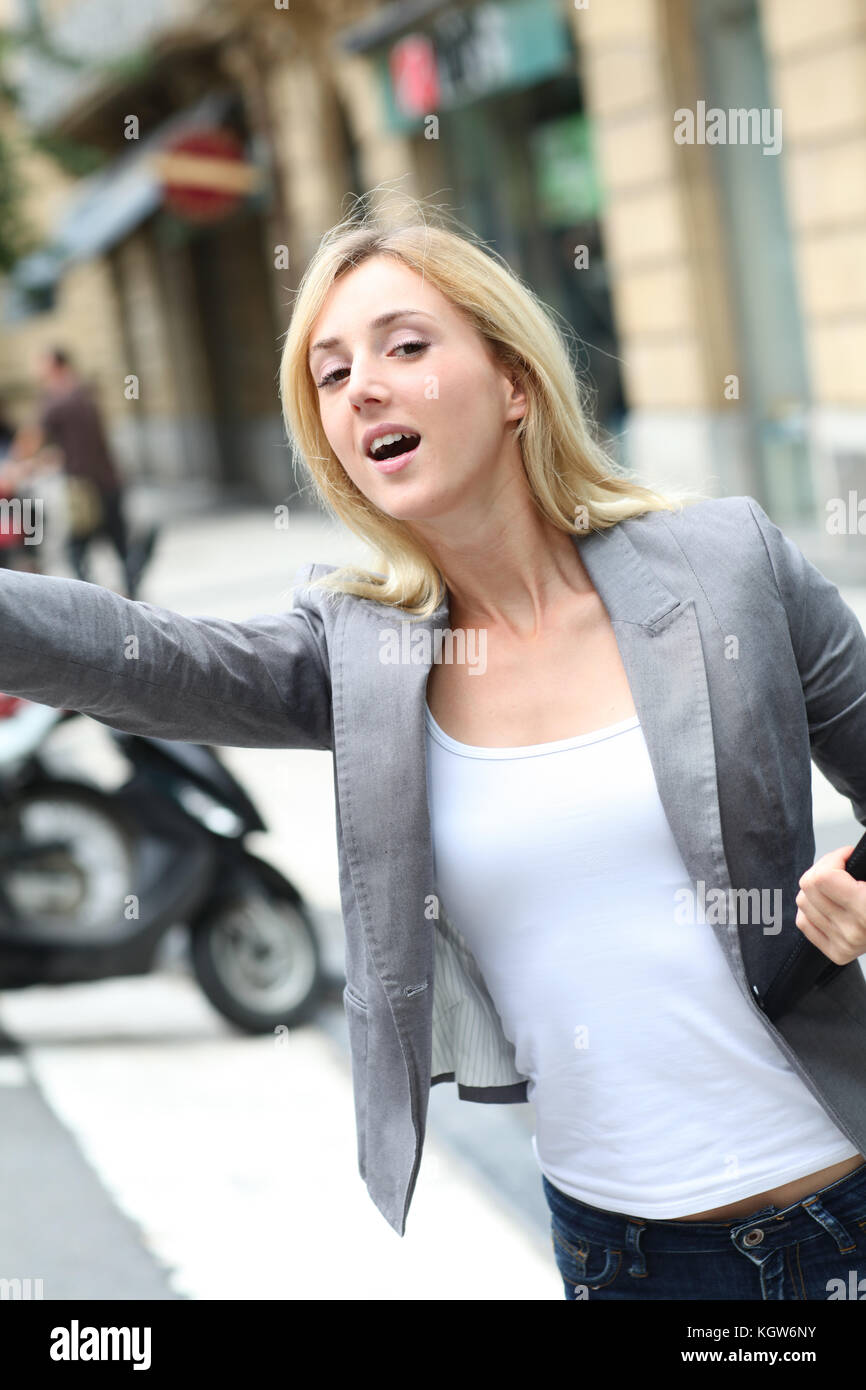 Businesswoman hailing for a cab Stock Photo - Alamy