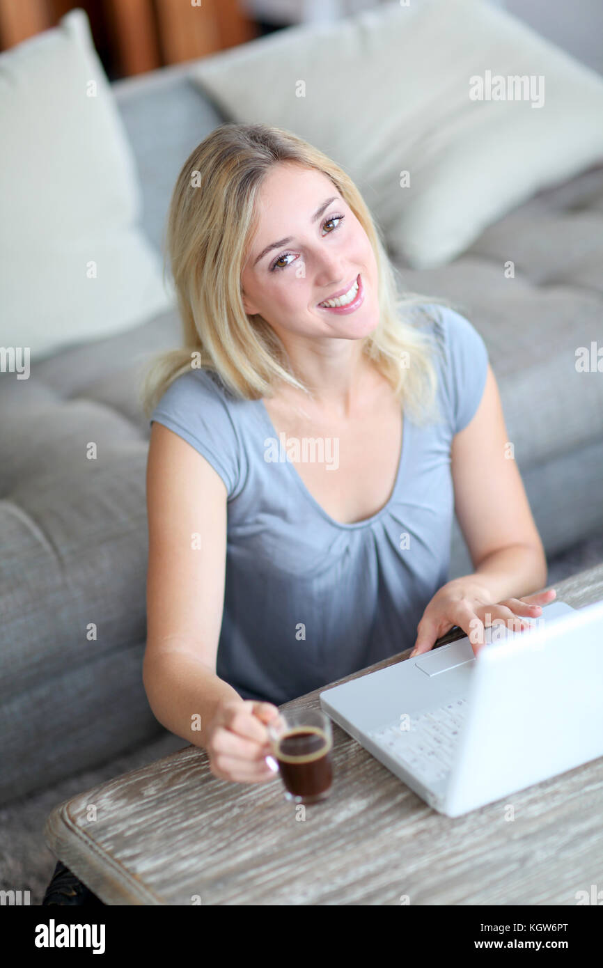 Girl laying in sofa with laptop computer Stock Photo - Alamy