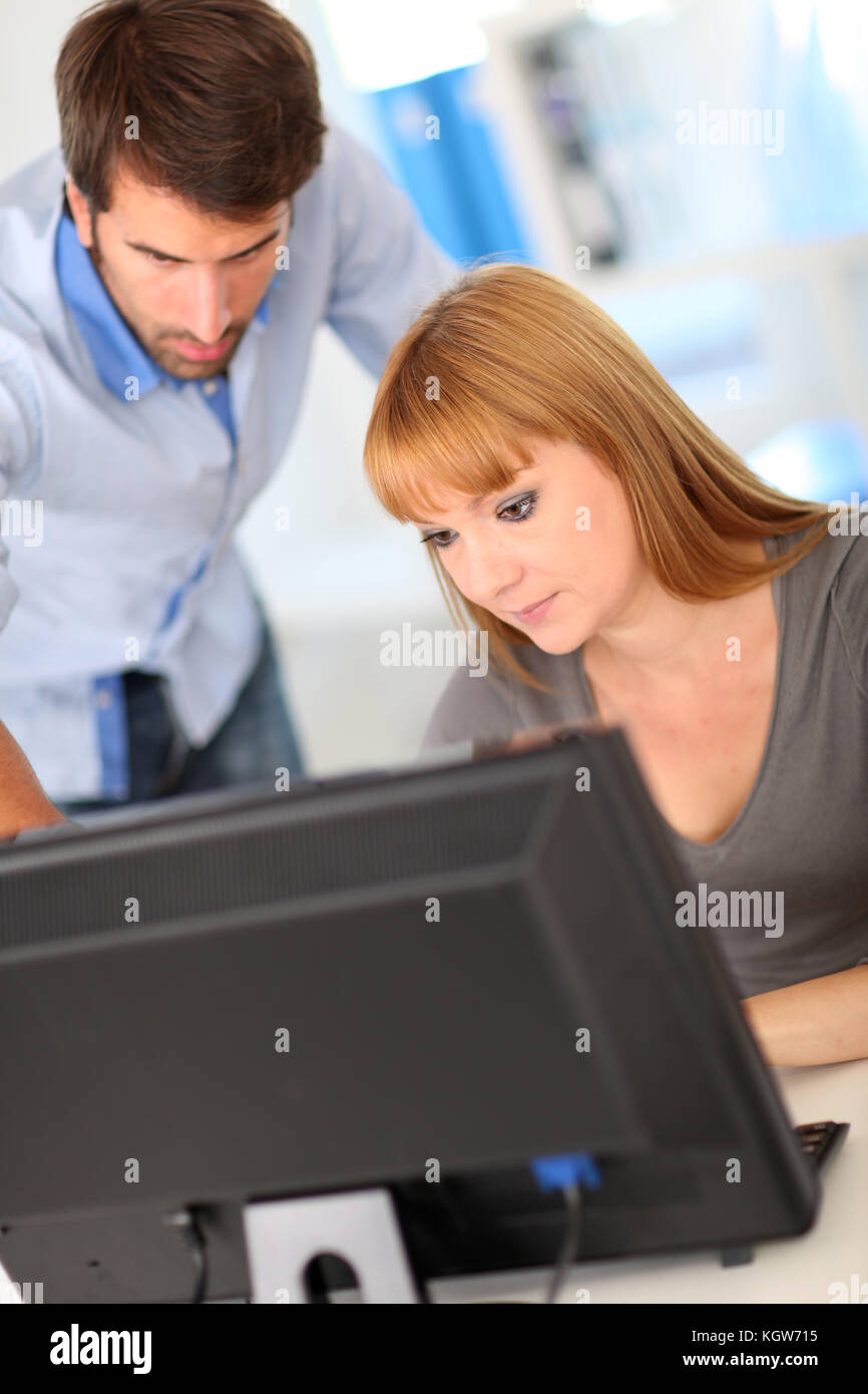 Business people working on desktop computer Stock Photo - Alamy