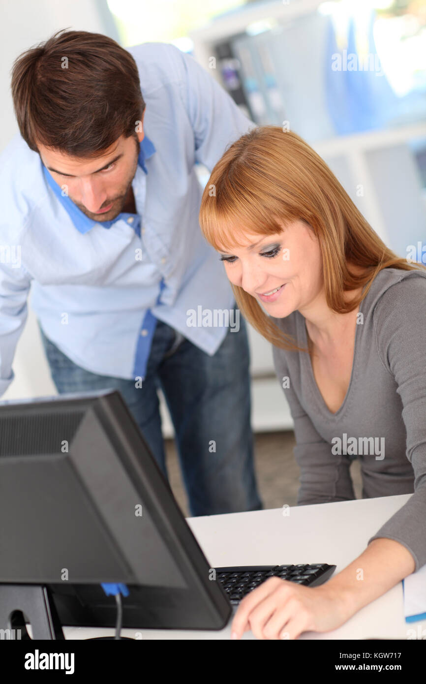 Business people working on desktop computer Stock Photo - Alamy