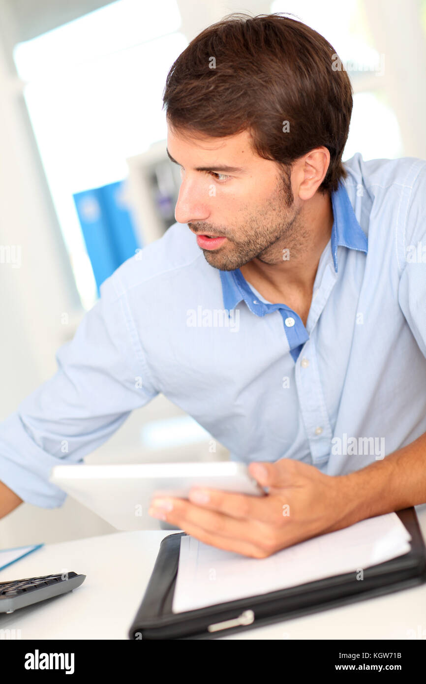 Office worker using tablet at work Stock Photo - Alamy