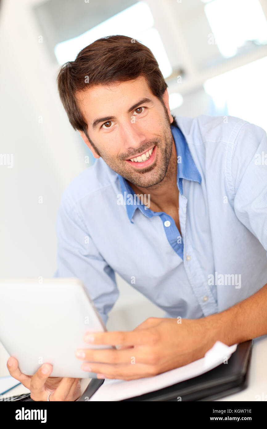 Portrait of office worker using electronic tablet Stock Photo - Alamy