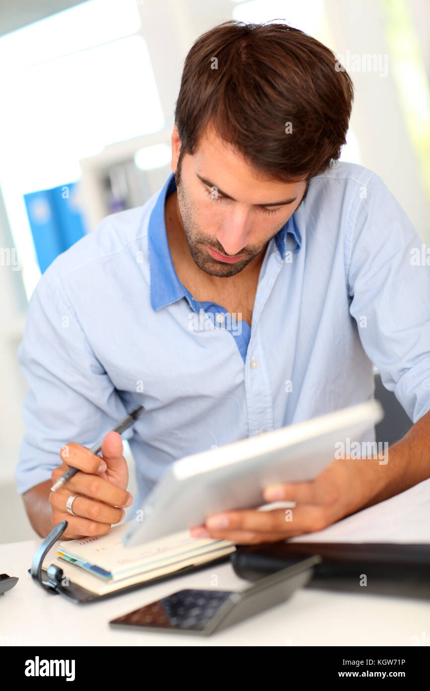Portrait of office worker using electronic tablet Stock Photo - Alamy