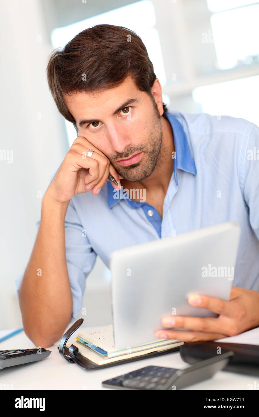 Portrait of office worker using electronic tablet Stock Photo - Alamy