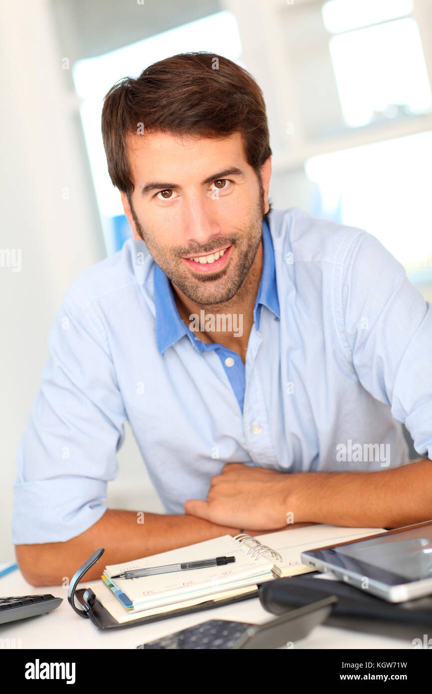 Portrait of smiling office worker Stock Photo - Alamy