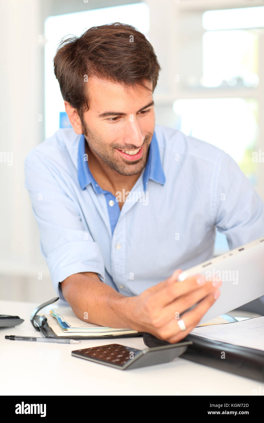 Portrait of office worker using electronic tablet Stock Photo - Alamy