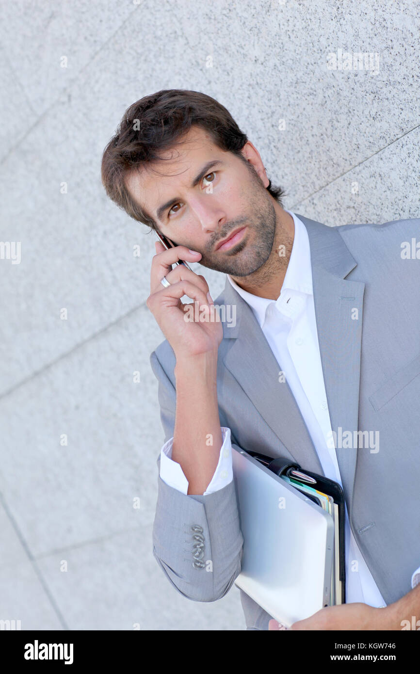 Portrait of salesman talking on mobile phone Stock Photo - Alamy