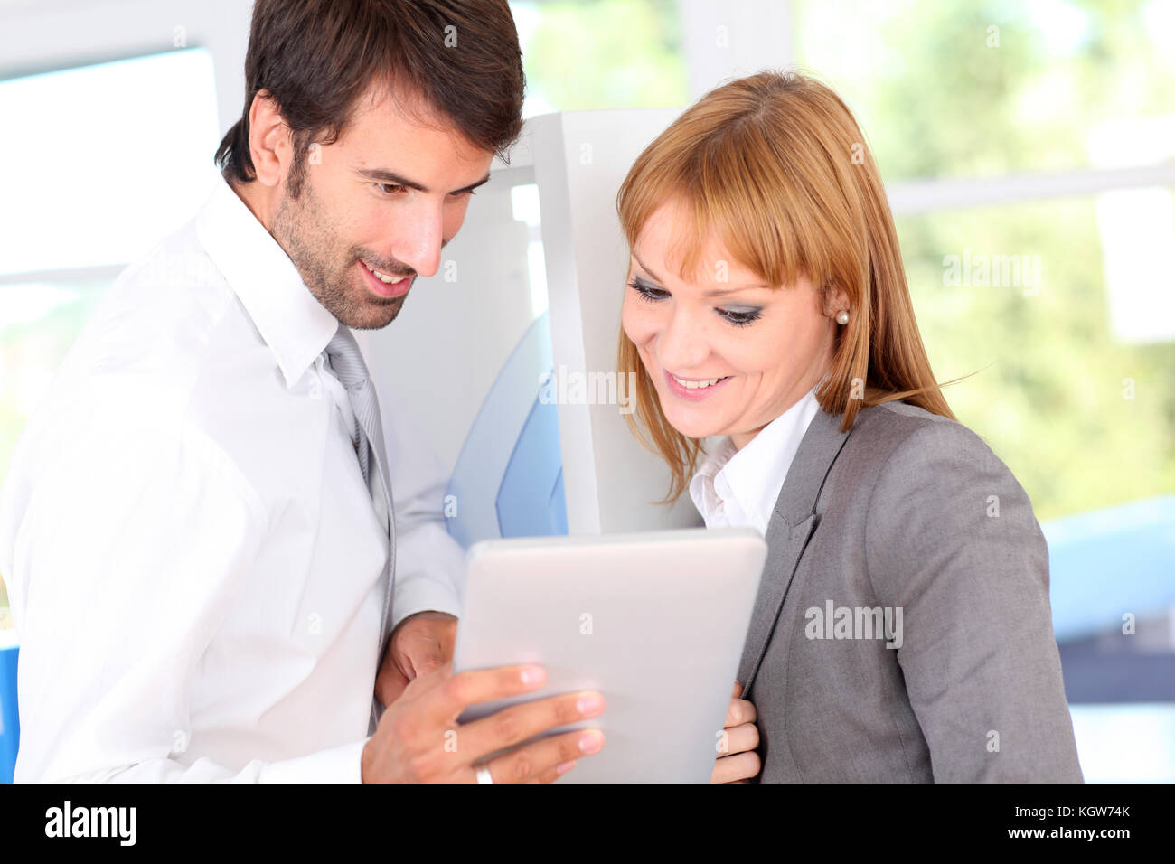 Business people in office using electronic tablet Stock Photo - Alamy