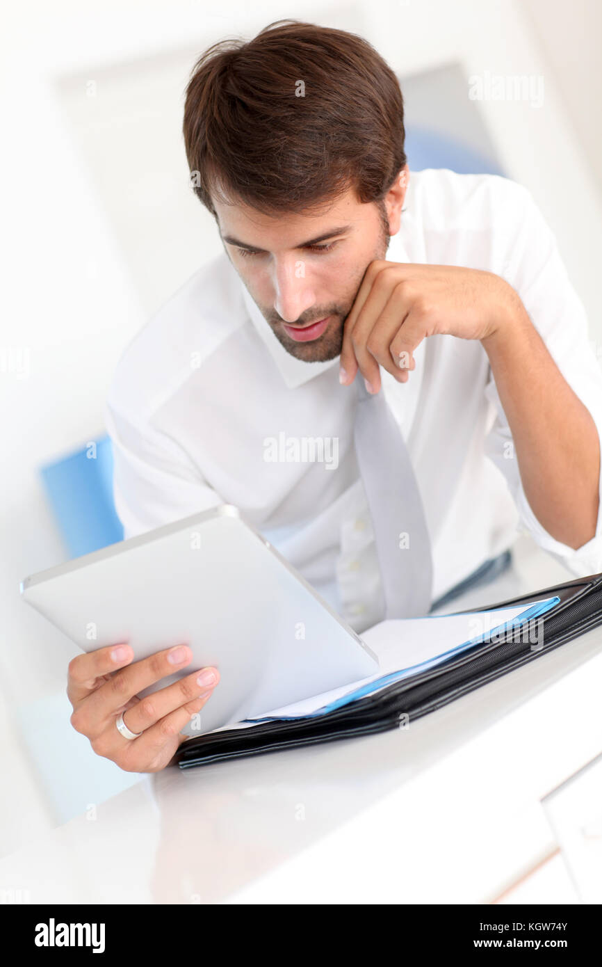 Office worker using electronic tablet Stock Photo - Alamy