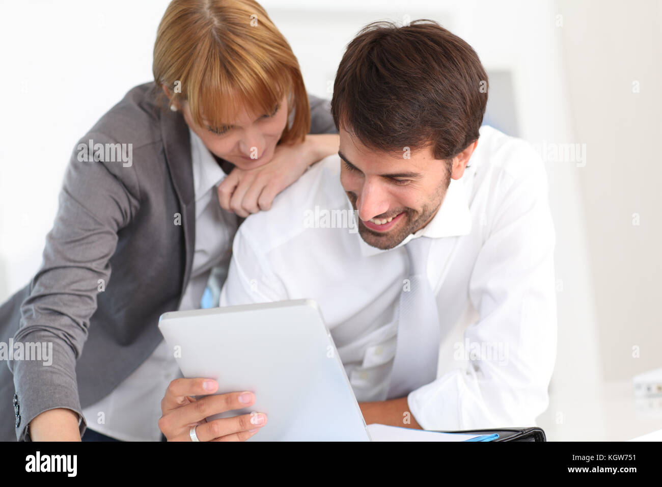 Business people in office using electronic tablet Stock Photo - Alamy