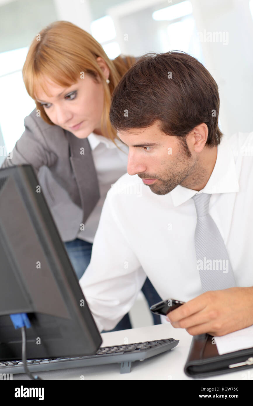 Business team in office working on desktop computer Stock Photo - Alamy