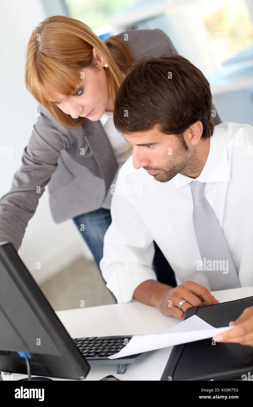 Business team in office working on desktop computer Stock Photo - Alamy