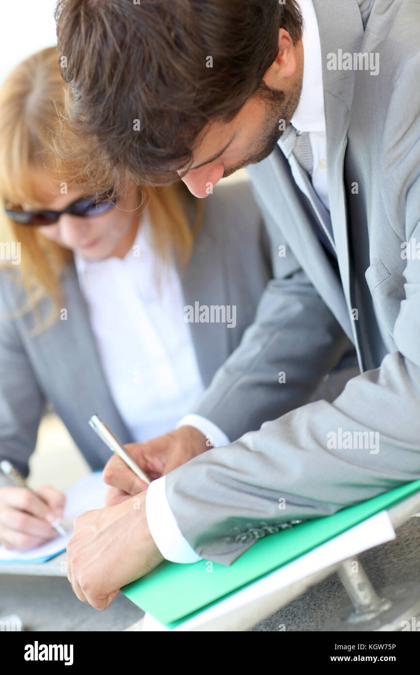 Business people signing contract Stock Photo - Alamy