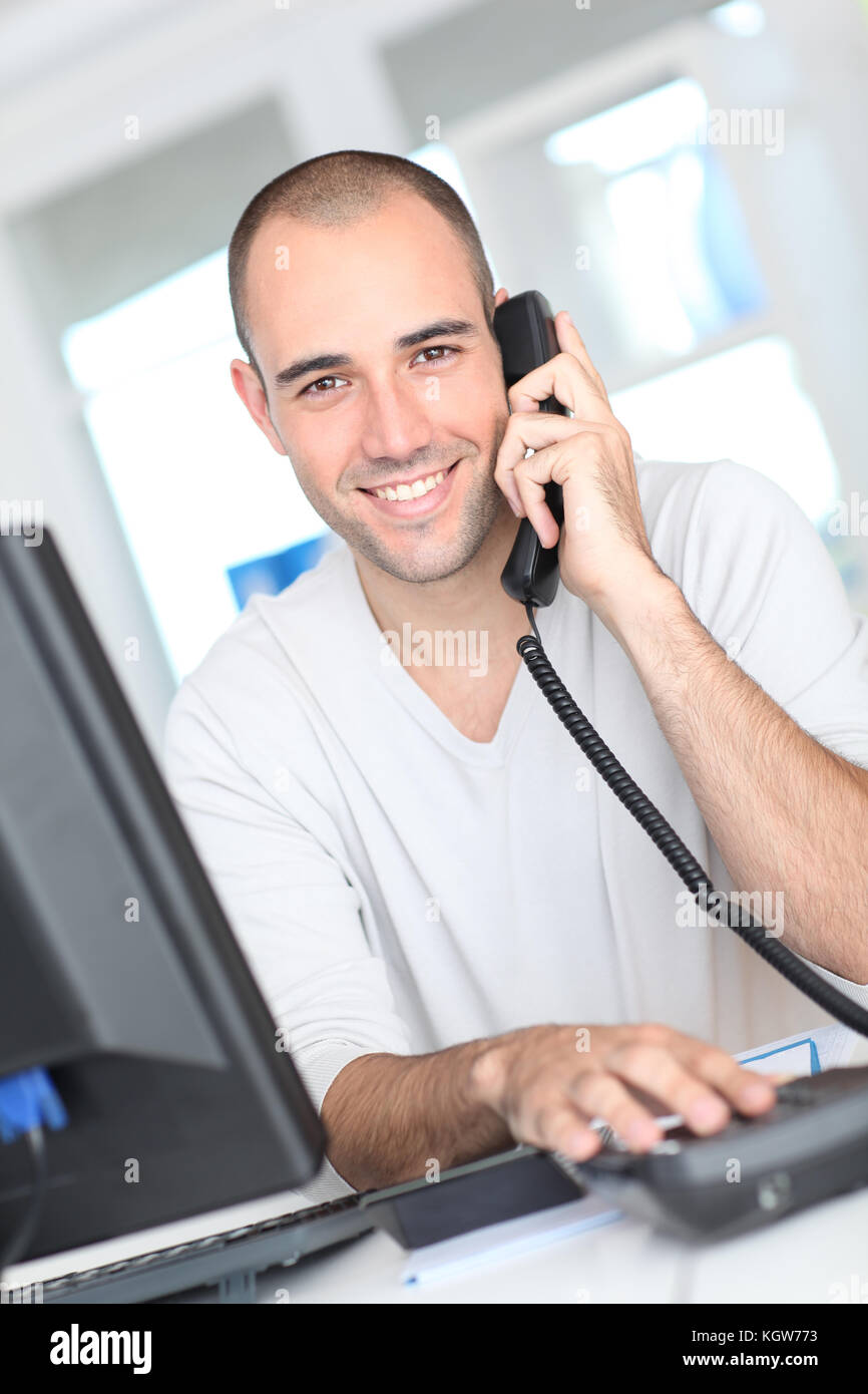 Smiling man answering the phone Stock Photo - Alamy