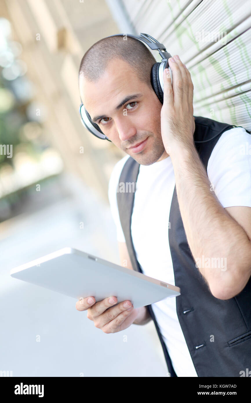 Young man using electronic tablet in the street Stock Photo - Alamy