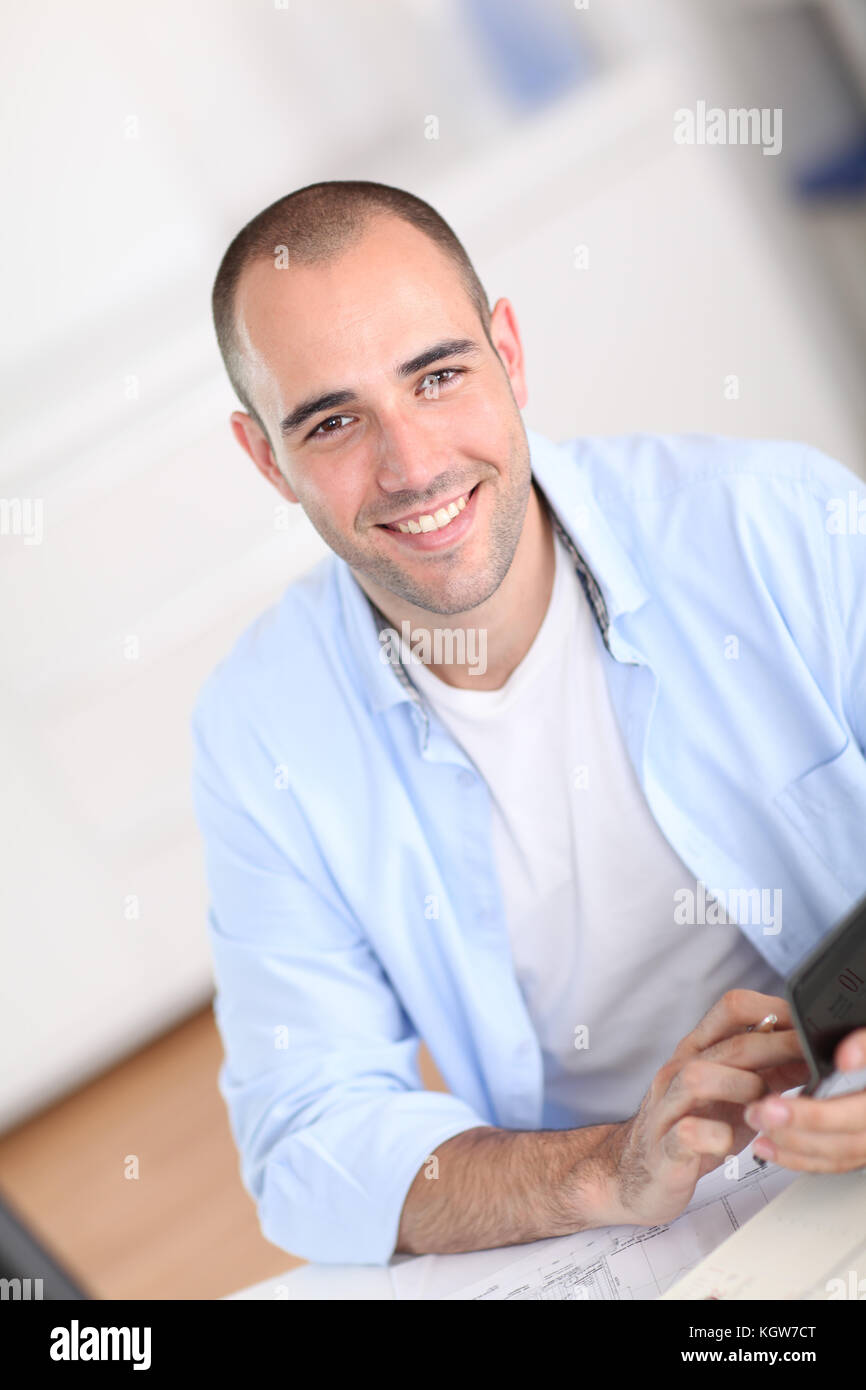 Smiling man sitting in office Stock Photo - Alamy