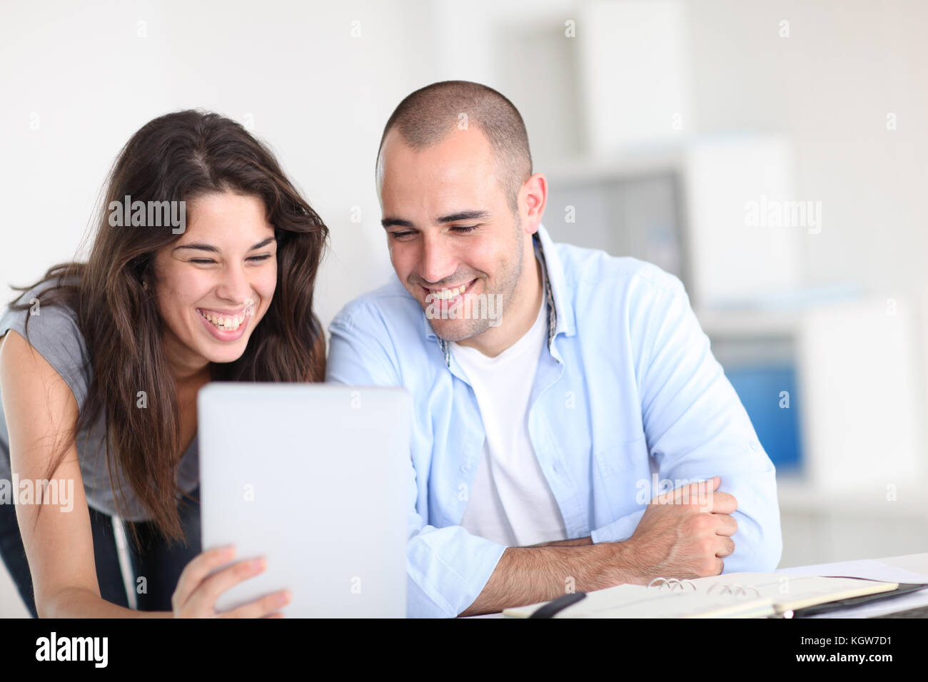 Workmates working on project with electronic tablet Stock Photo - Alamy