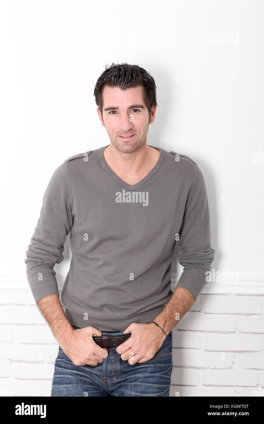 Young man leaning on white background Stock Photo - Alamy