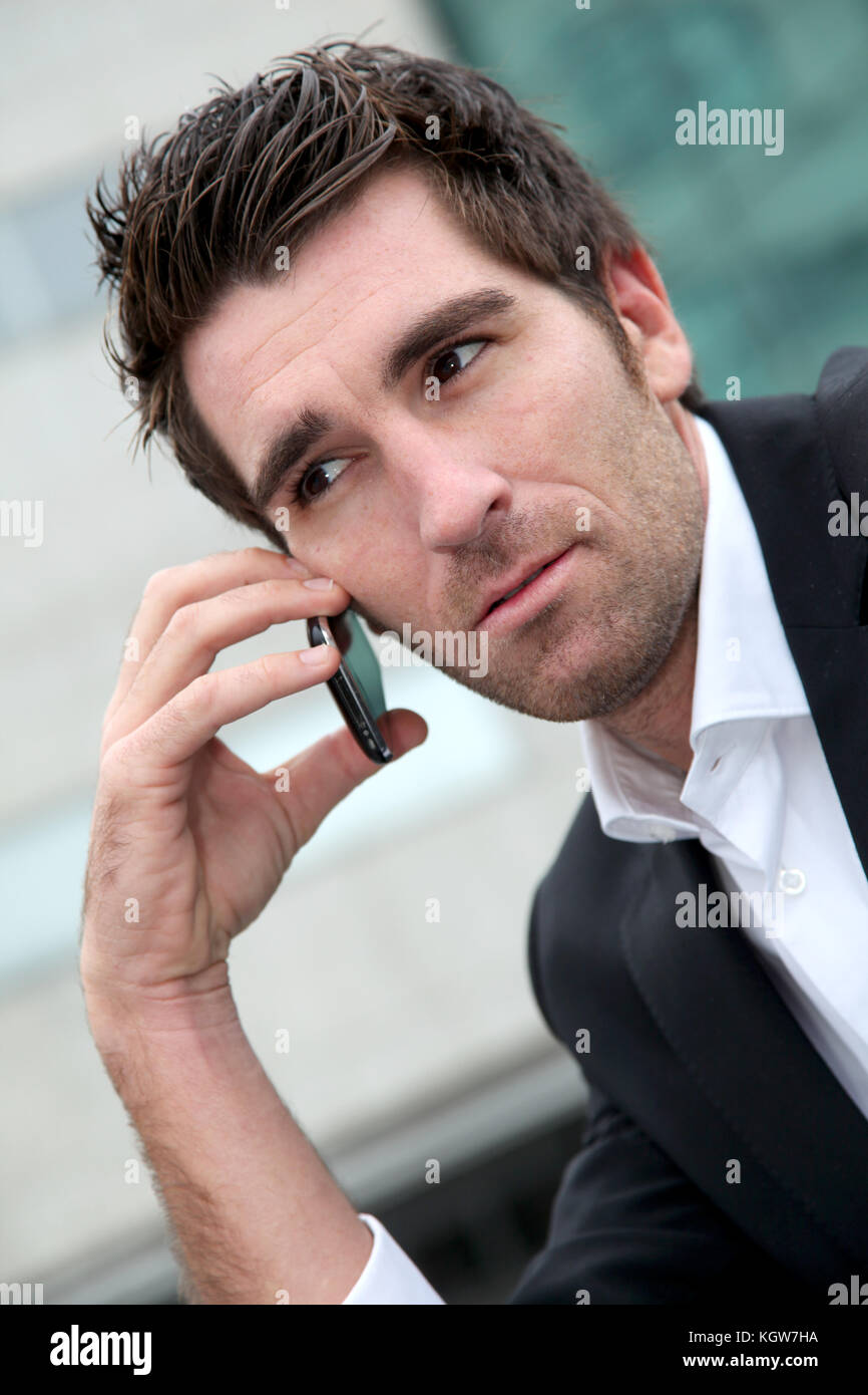 Man using cellphone in town Stock Photo - Alamy