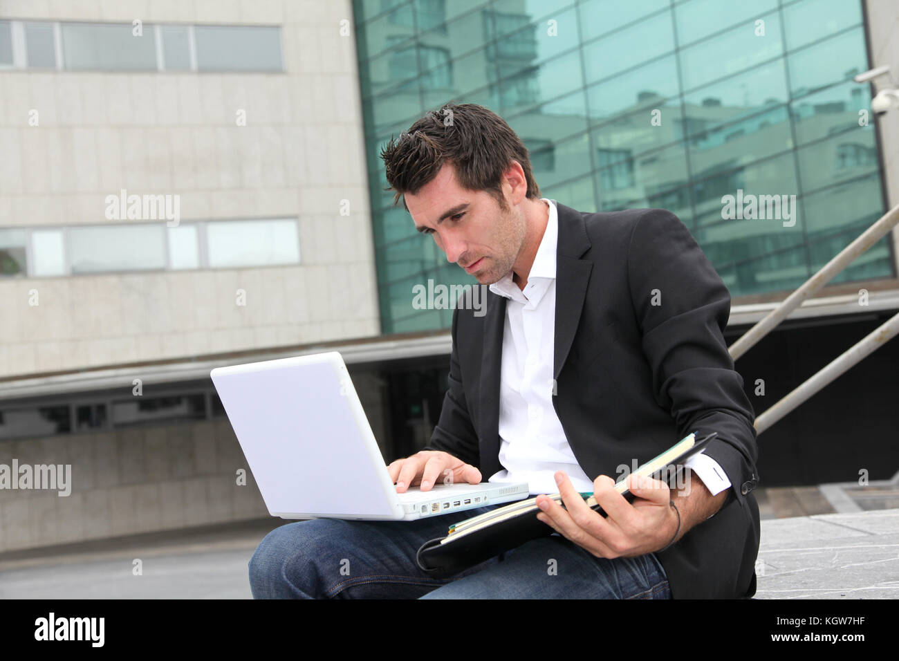 Salesman working outside building of offices Stock Photo - Alamy