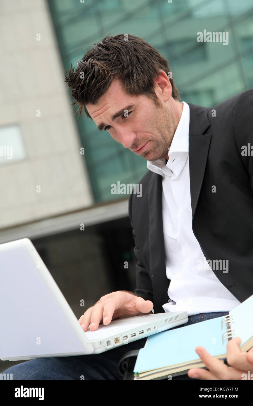 Salesman working outside building of offices Stock Photo - Alamy