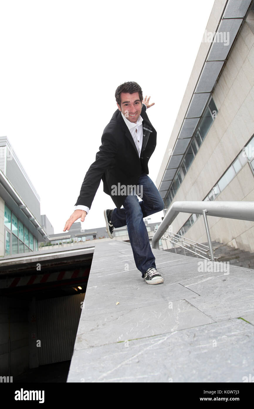 Man running downstairs with stretched arms Stock Photo - Alamy