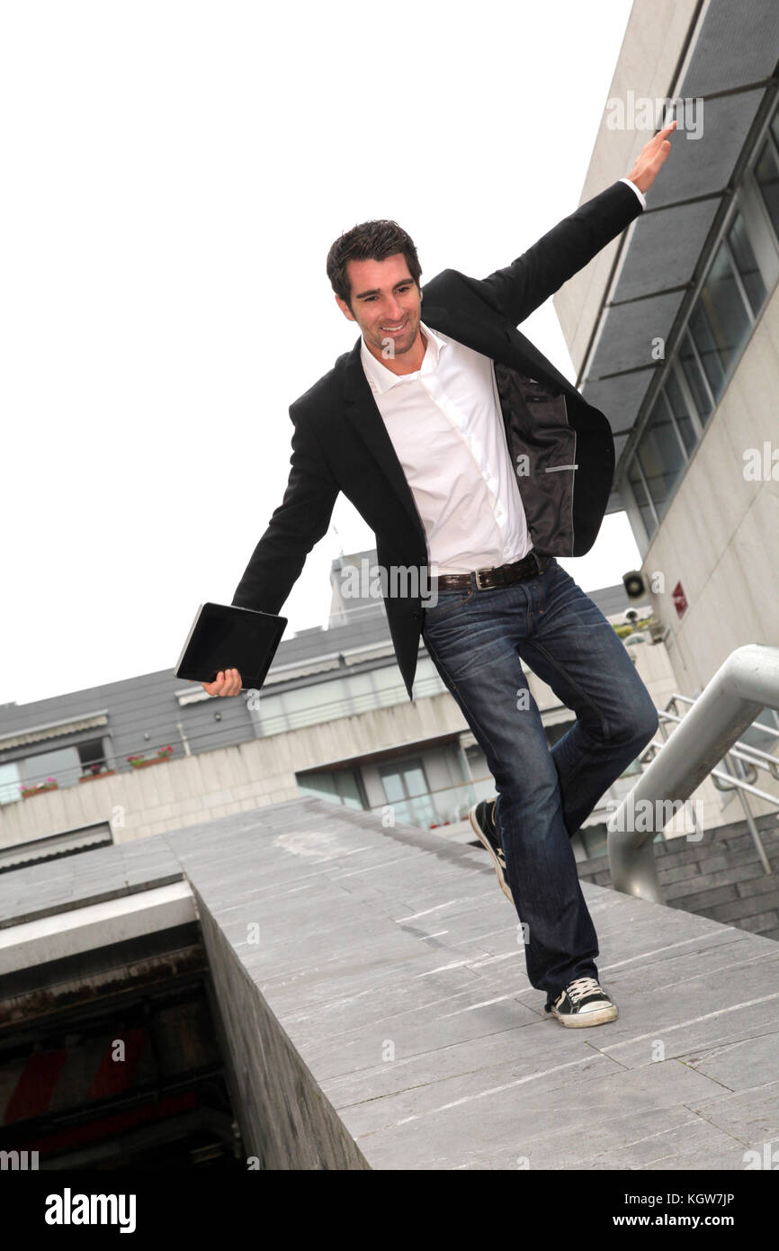 Man running downstairs with stretched arms Stock Photo - Alamy