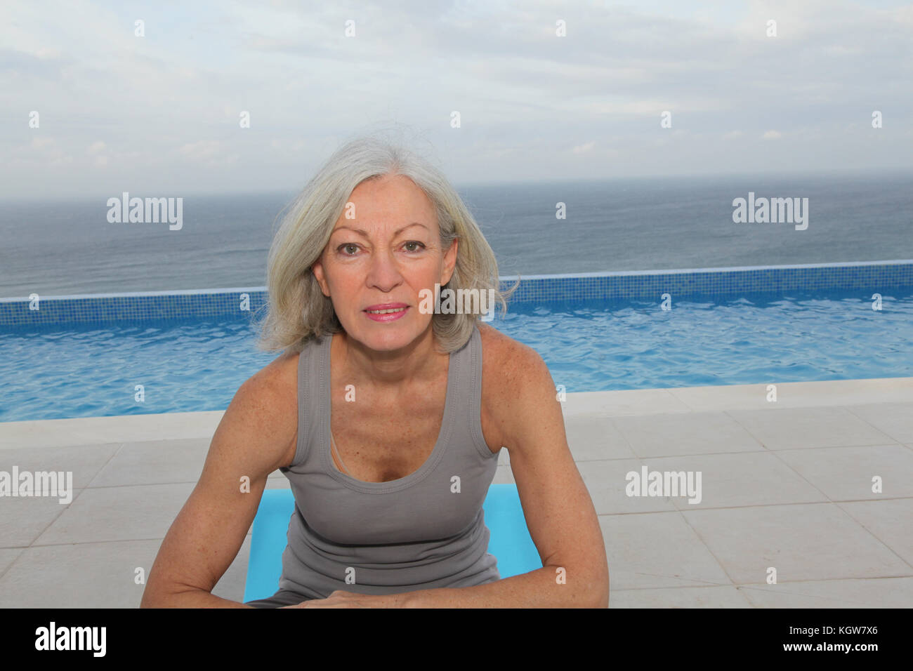 Senior woman doing exercises by a swimming-pool Stock Photo - Alamy