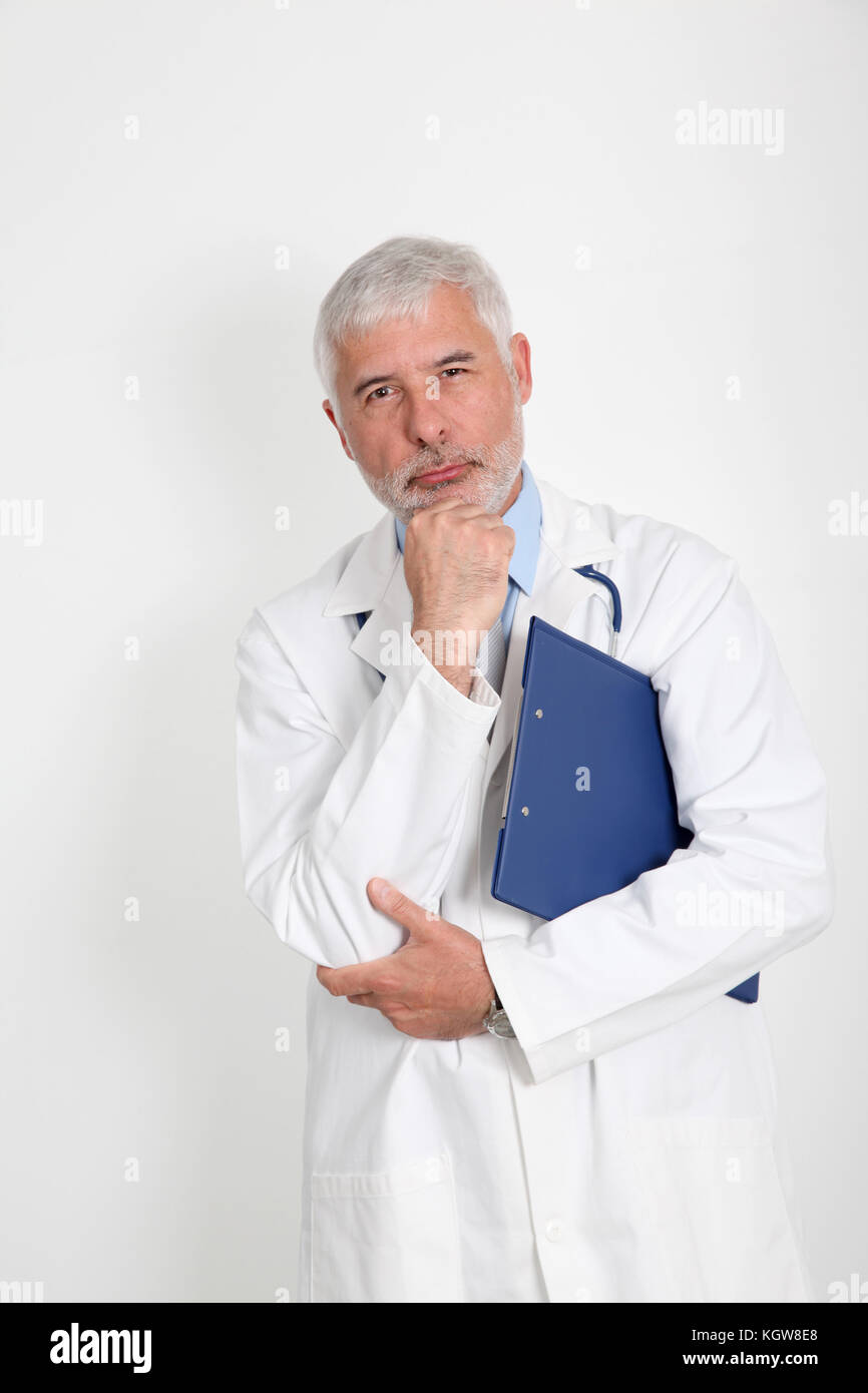 Senior doctor with hand on chin Stock Photo - Alamy