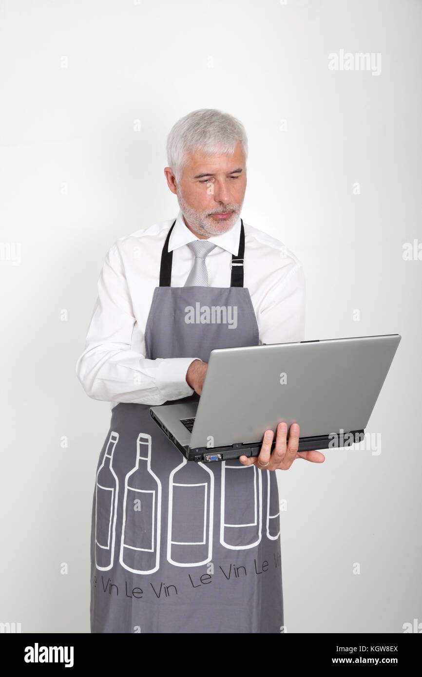 Wine waiter using laptop computer Stock Photo - Alamy