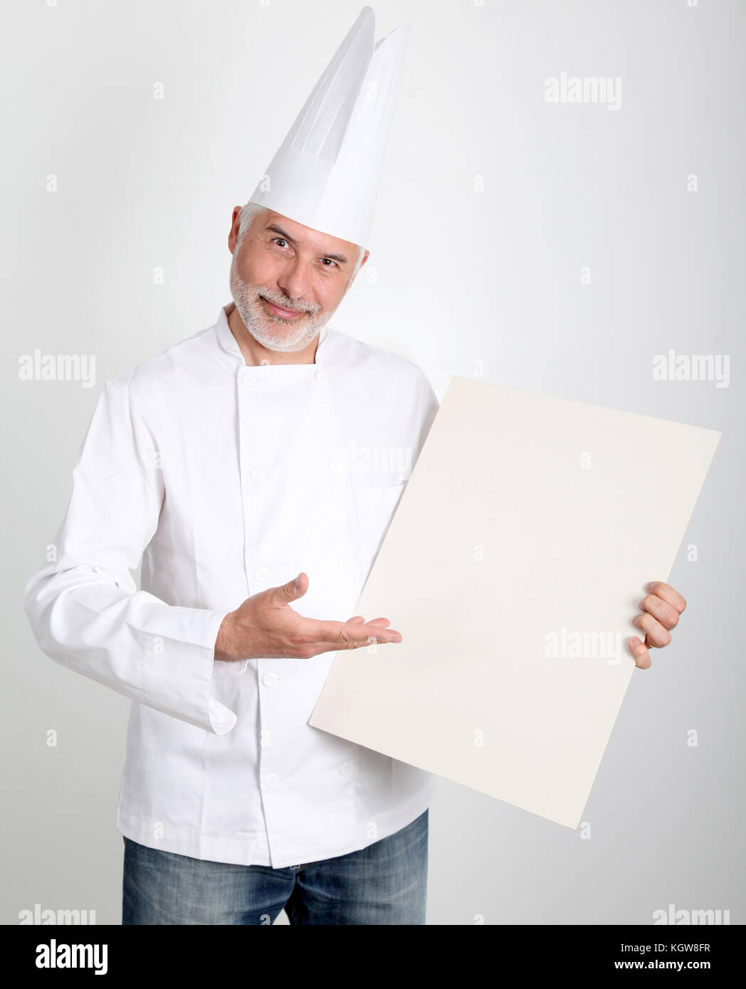 Smiling chef showing restaurant menu Stock Photo - Alamy