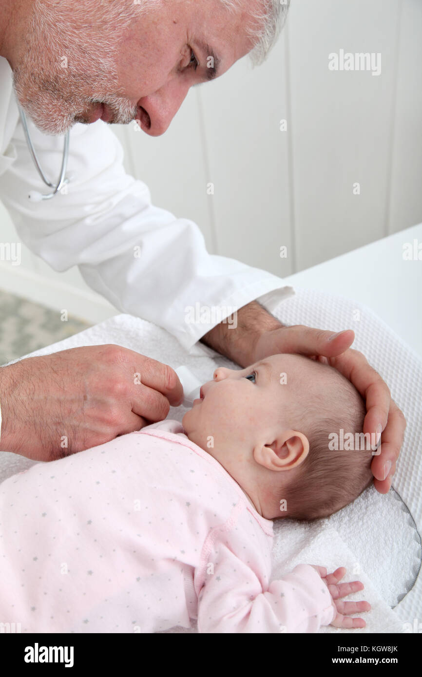 Pediatrician examining baby's ear Stock Photo - Alamy
