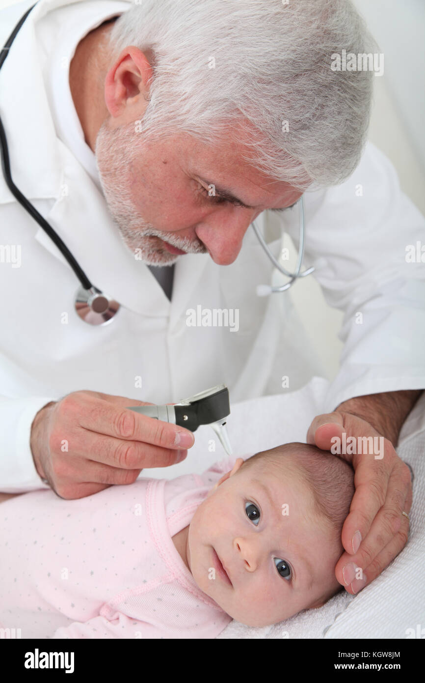 Pediatrician examining baby's ear Stock Photo - Alamy