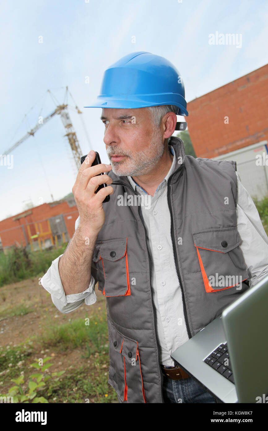 Construction manager on building site with laptop computer Stock Photo ...