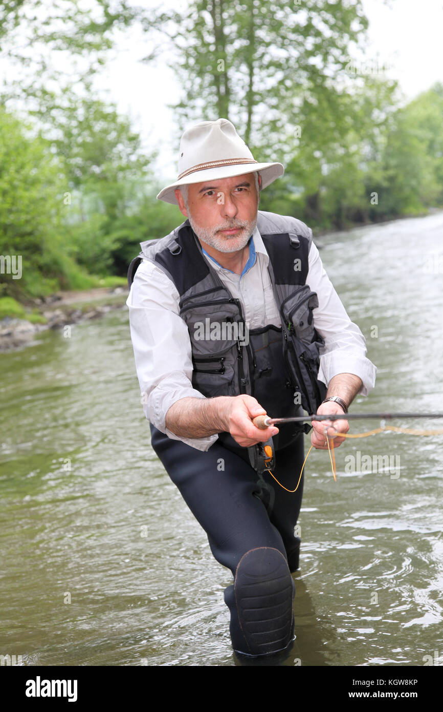 Man fishing trout in river Stock Photo - Alamy