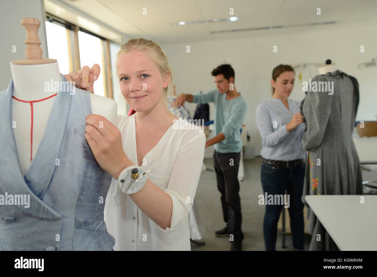 Girl in dressmaking class working on mannequin Stock Photo - Alamy