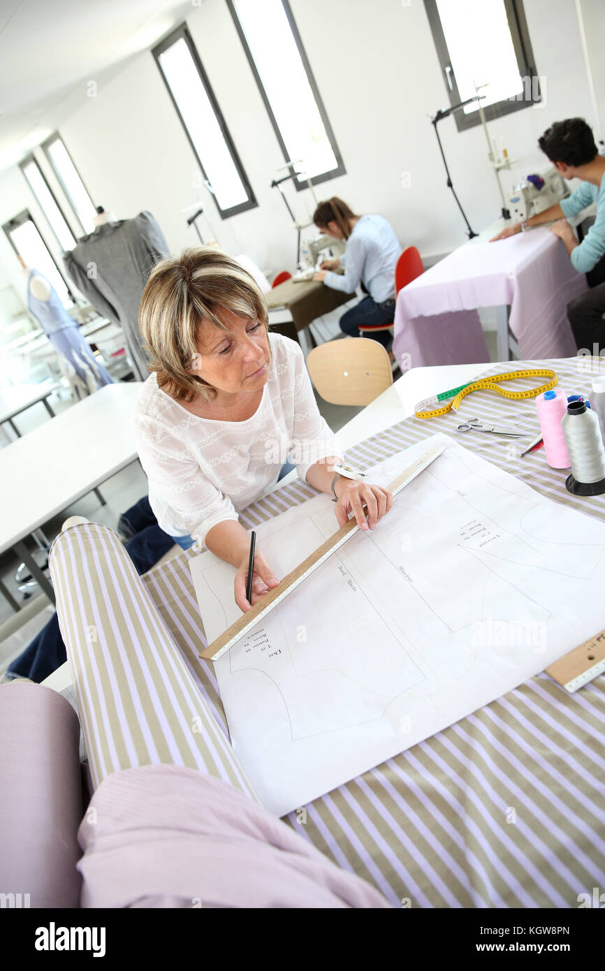 Closeup of dressmaker in training class Stock Photo - Alamy