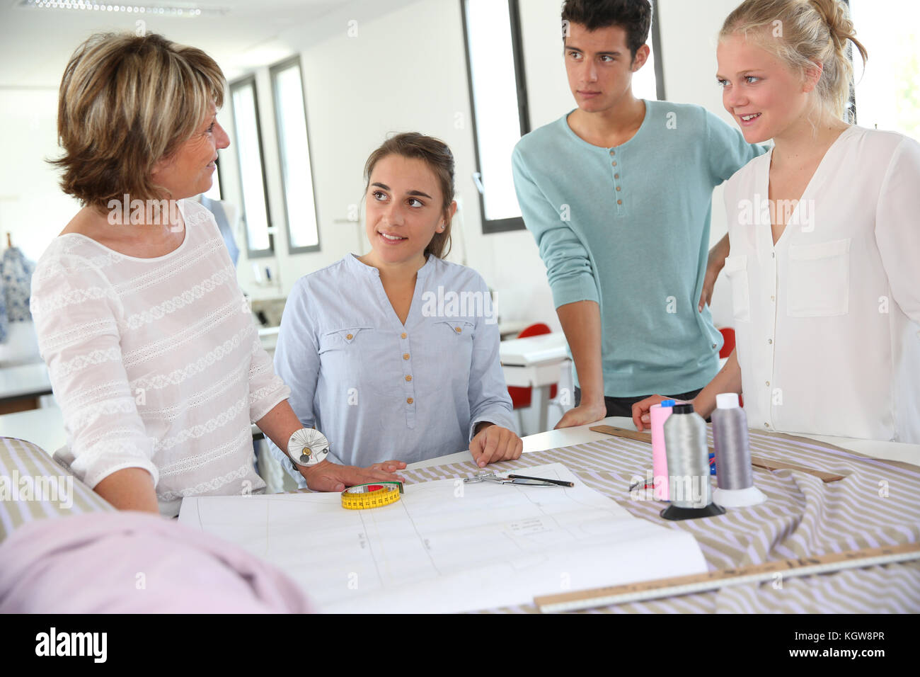 Group of students in dressmaking training school Stock Photo - Alamy