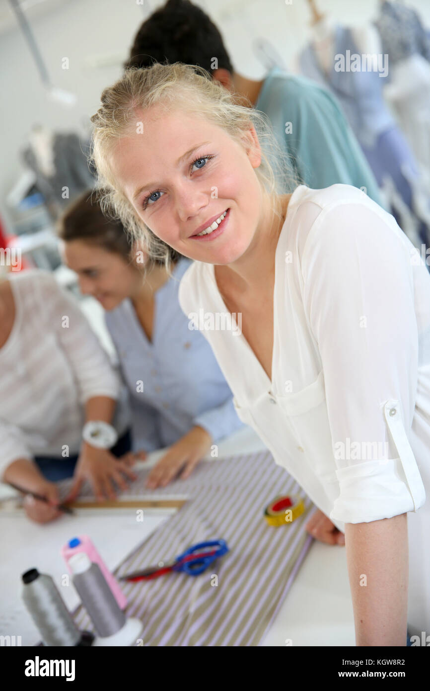 Portrait of smiling student girl in sewing class Stock Photo - Alamy