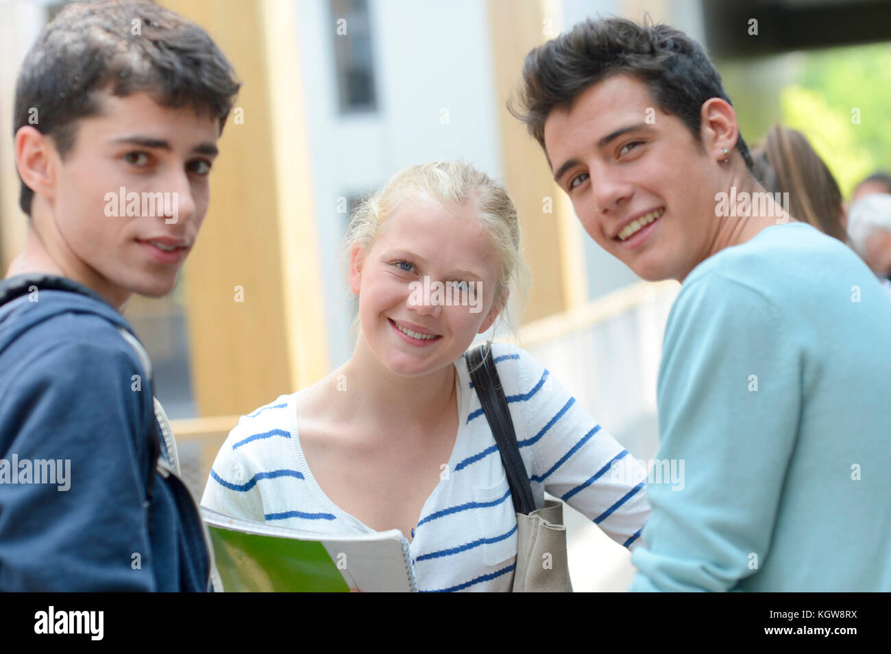 Cheerful students standing outside school building Stock Photo - Alamy