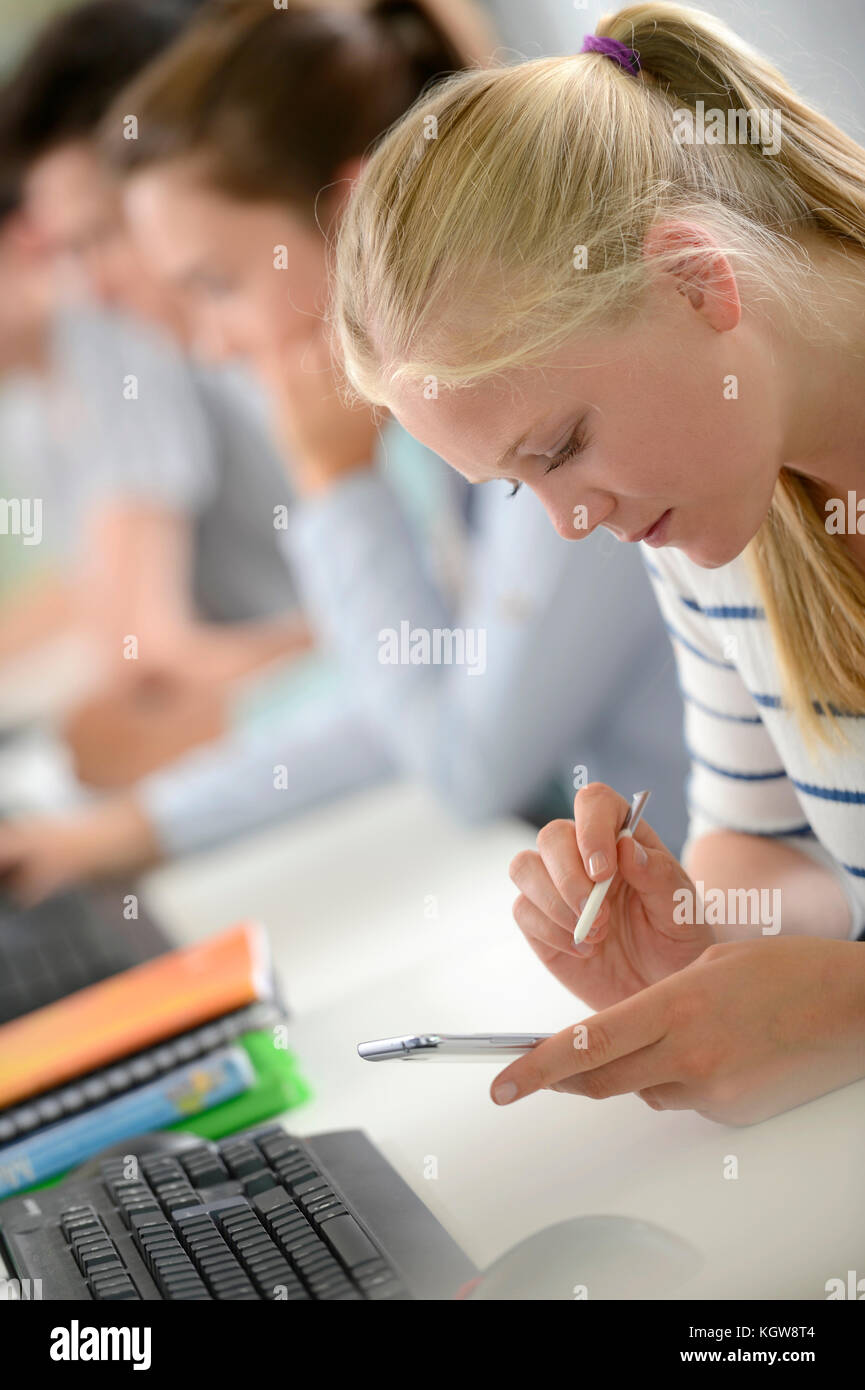 High-school girl using smartphone in class Stock Photo - Alamy