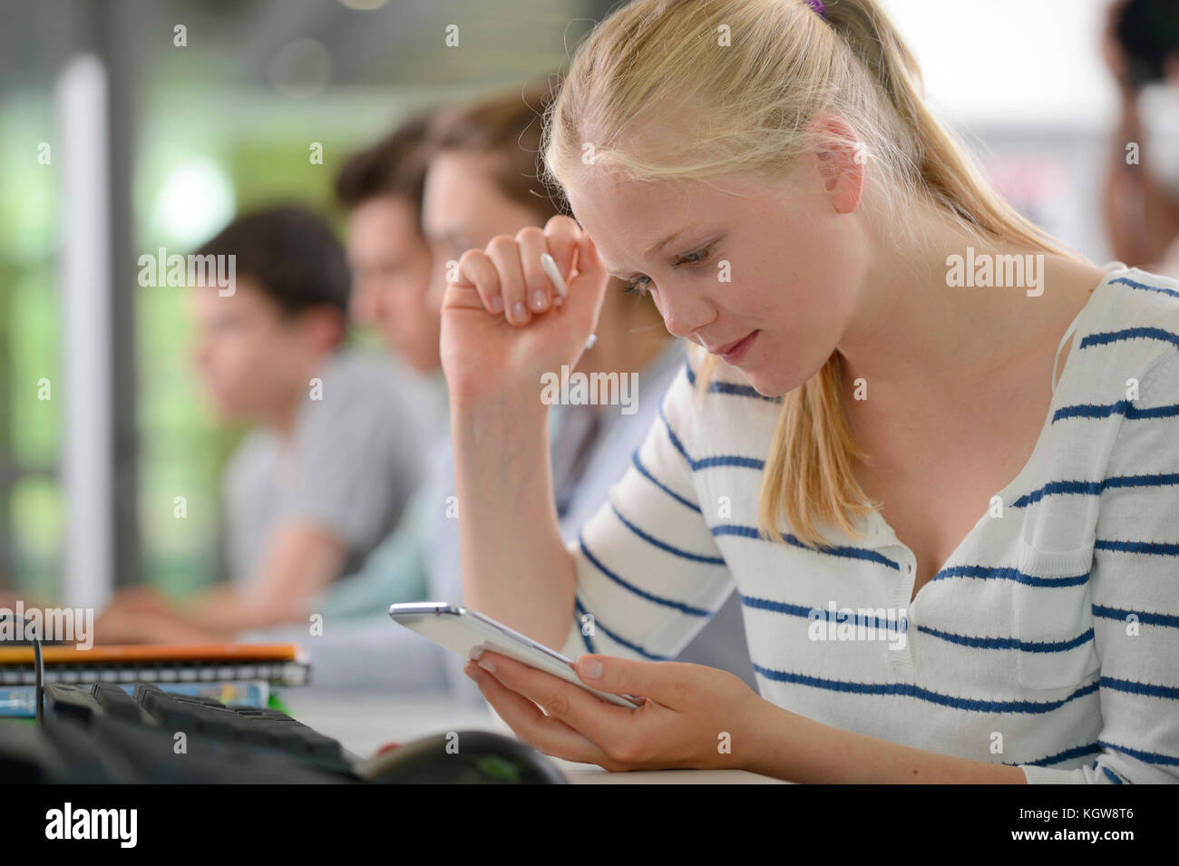 High-school girl using smartphone in class Stock Photo - Alamy