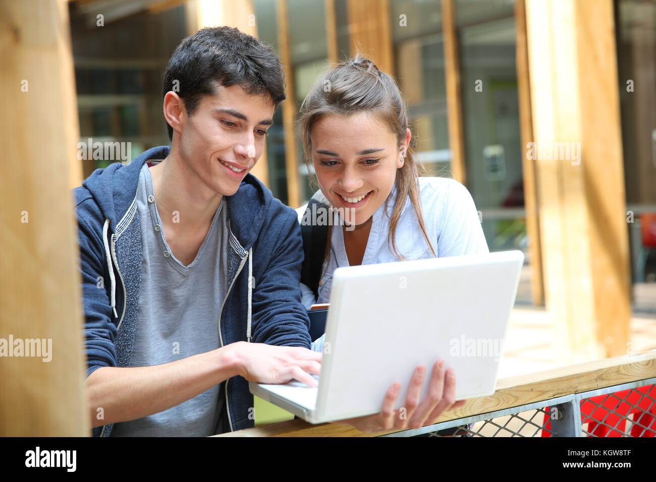 Teenagers working on laptop in school campus Stock Photo - Alamy