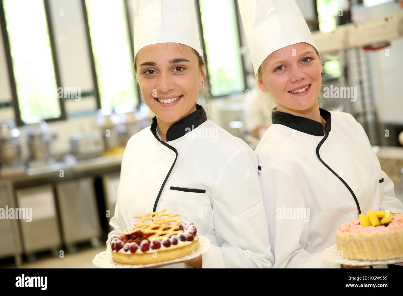 Students girls in pastry holding cakes Stock Photo - Alamy