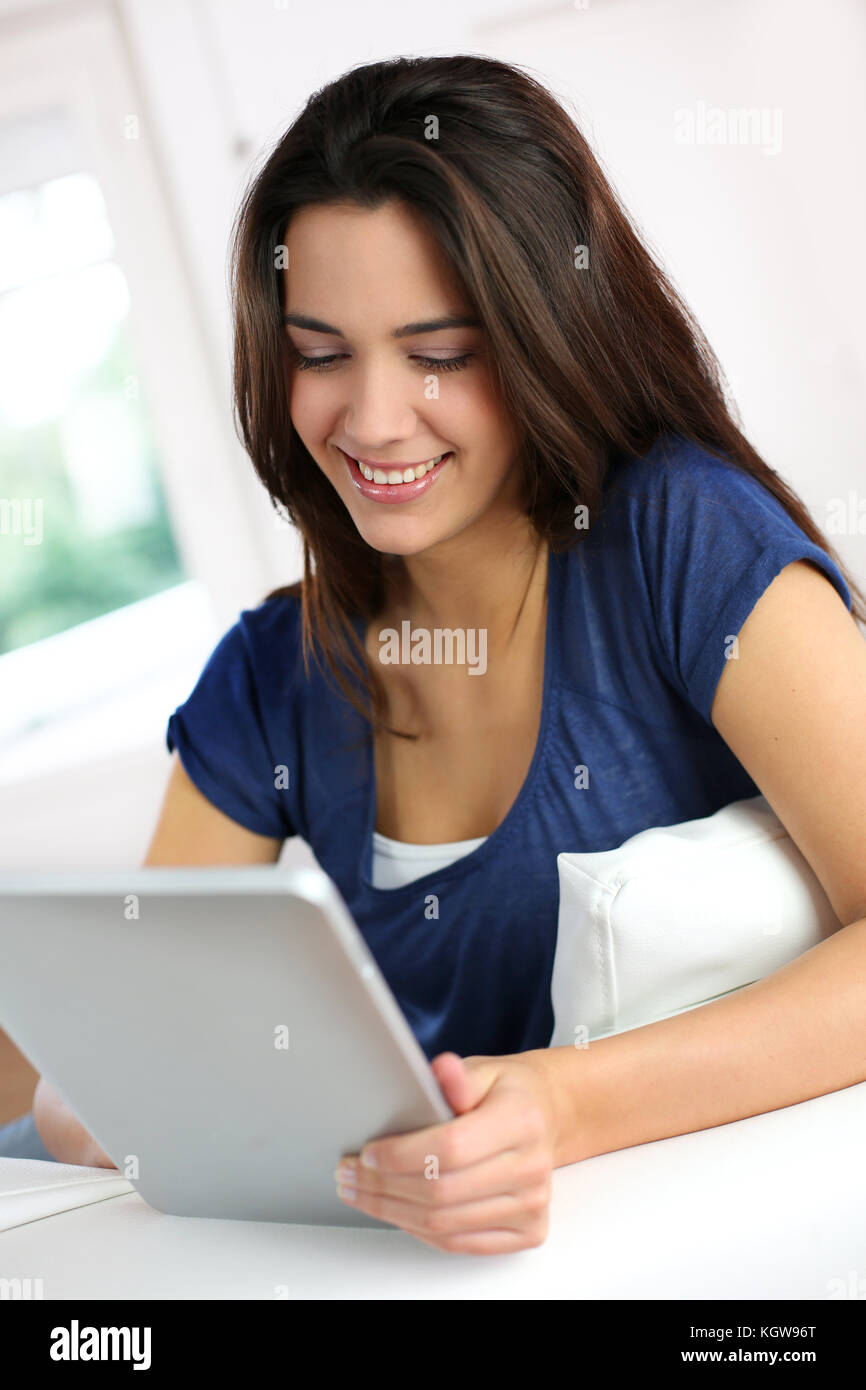 Smiling brunette girl using electronic tablet Stock Photo - Alamy